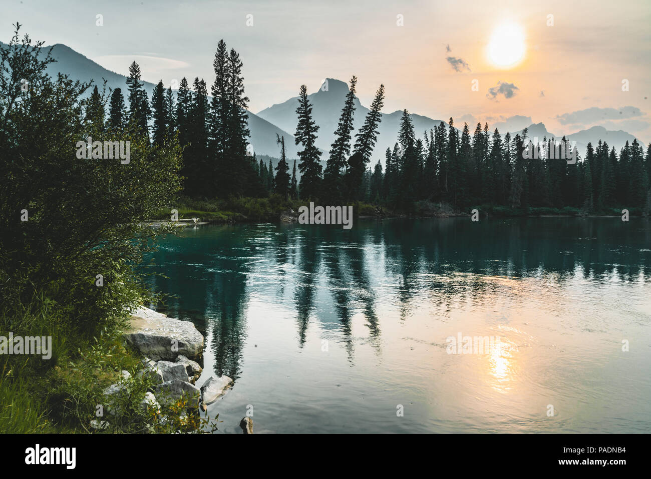 Scenic sunset views over bow river three sisters, Banff National Park ...