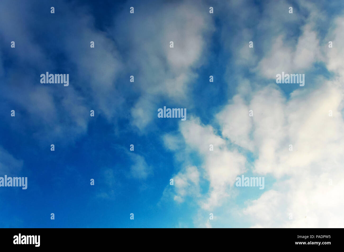 Blue sky with white abstract spindrift clouds Stock Photo - Alamy