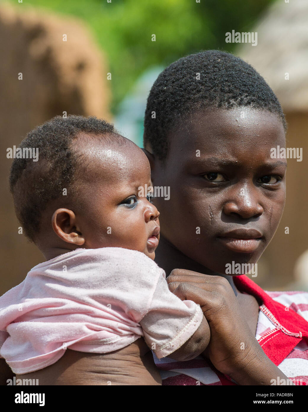 ACCRA, GHANA - MARCH 6, 2012: Unidentified Ghanaian mother carries her ...