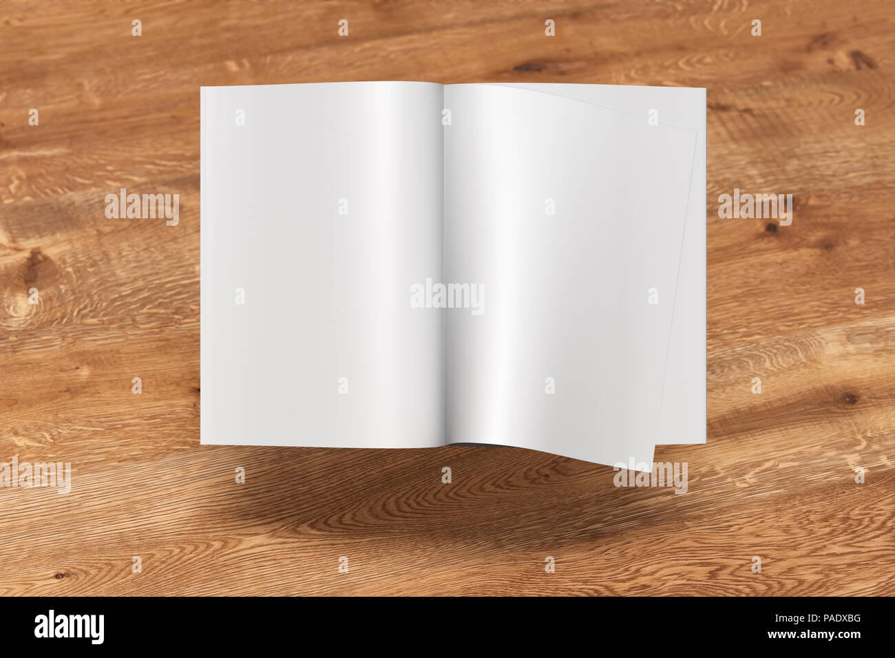 Blank magazine pages with bent glossy paper flying over wooden ...
