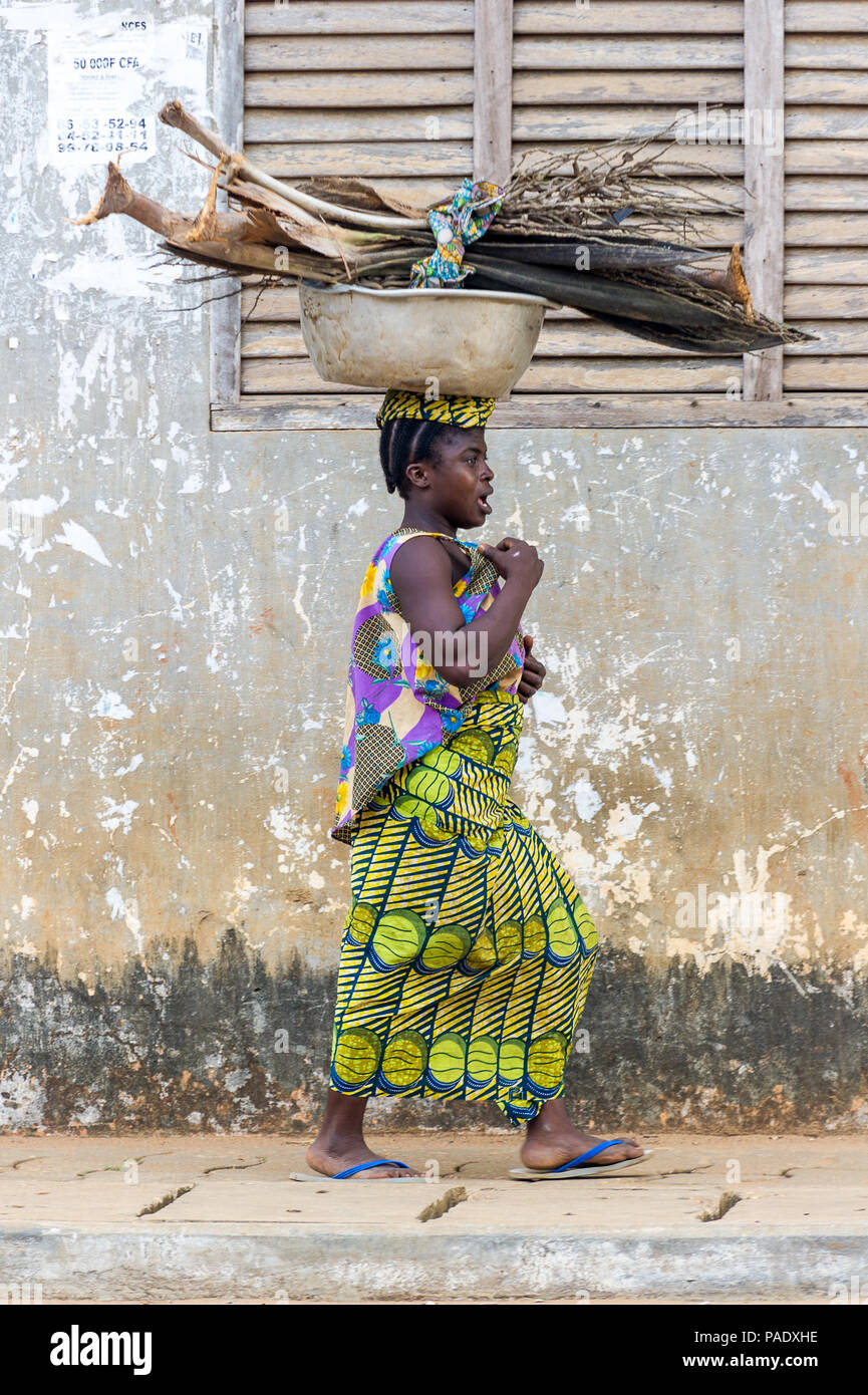 PORTO-NOVO, BENIN - MAR 10, 2012: Unidentified Beninese girl carries ...
