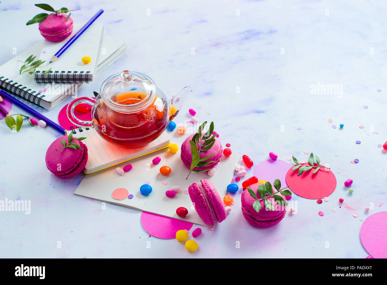 Glass teapot header with candies and confetti on a light background ...