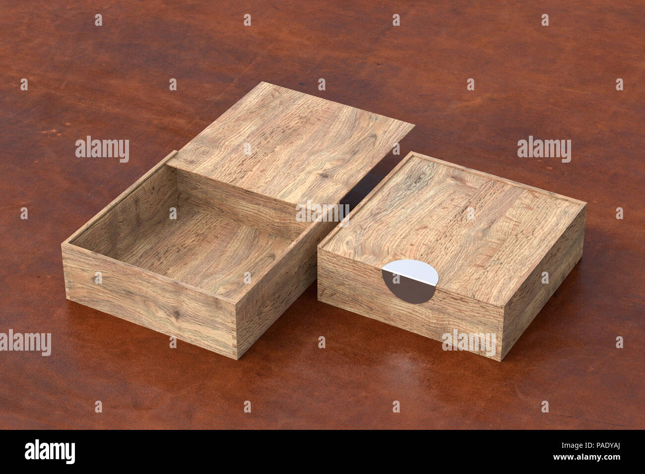 Two wooden square boxes with sliding lid on brown leather background ...