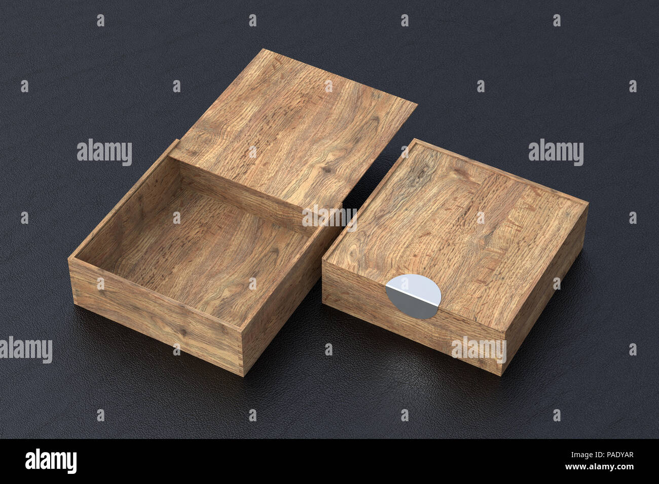 Two wooden square boxes with sliding lid on black leather background ...