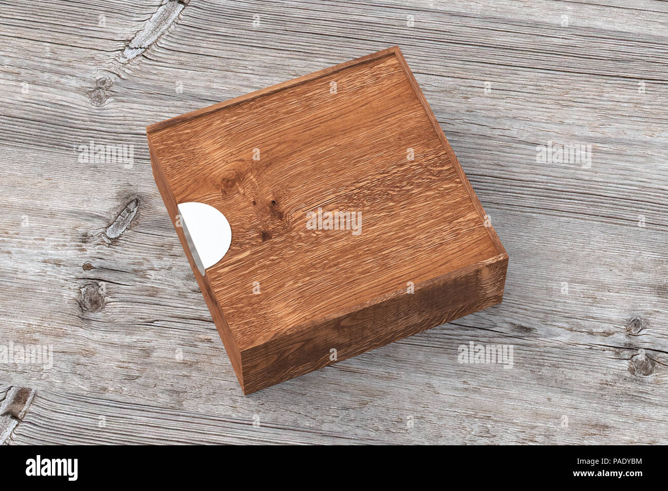Blank dark wooden square box with closed sliding lid on old wooden ...