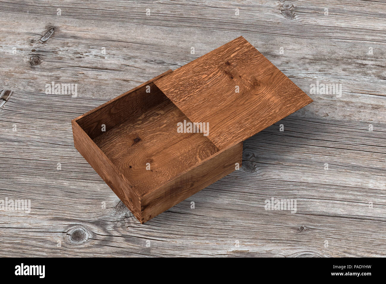 Empty dark wooden square box with opened sliding lid on old wooden ...