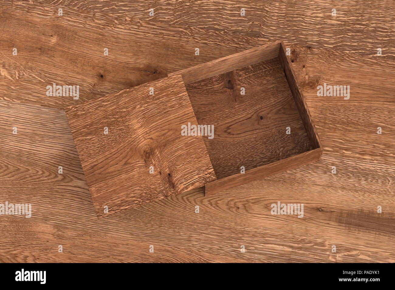 Empty dark wooden square box with opened sliding lid on dark wooden ...