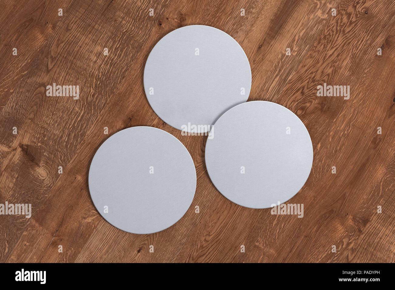 Three round white coasters on wood background. 3d illustration Stock ...