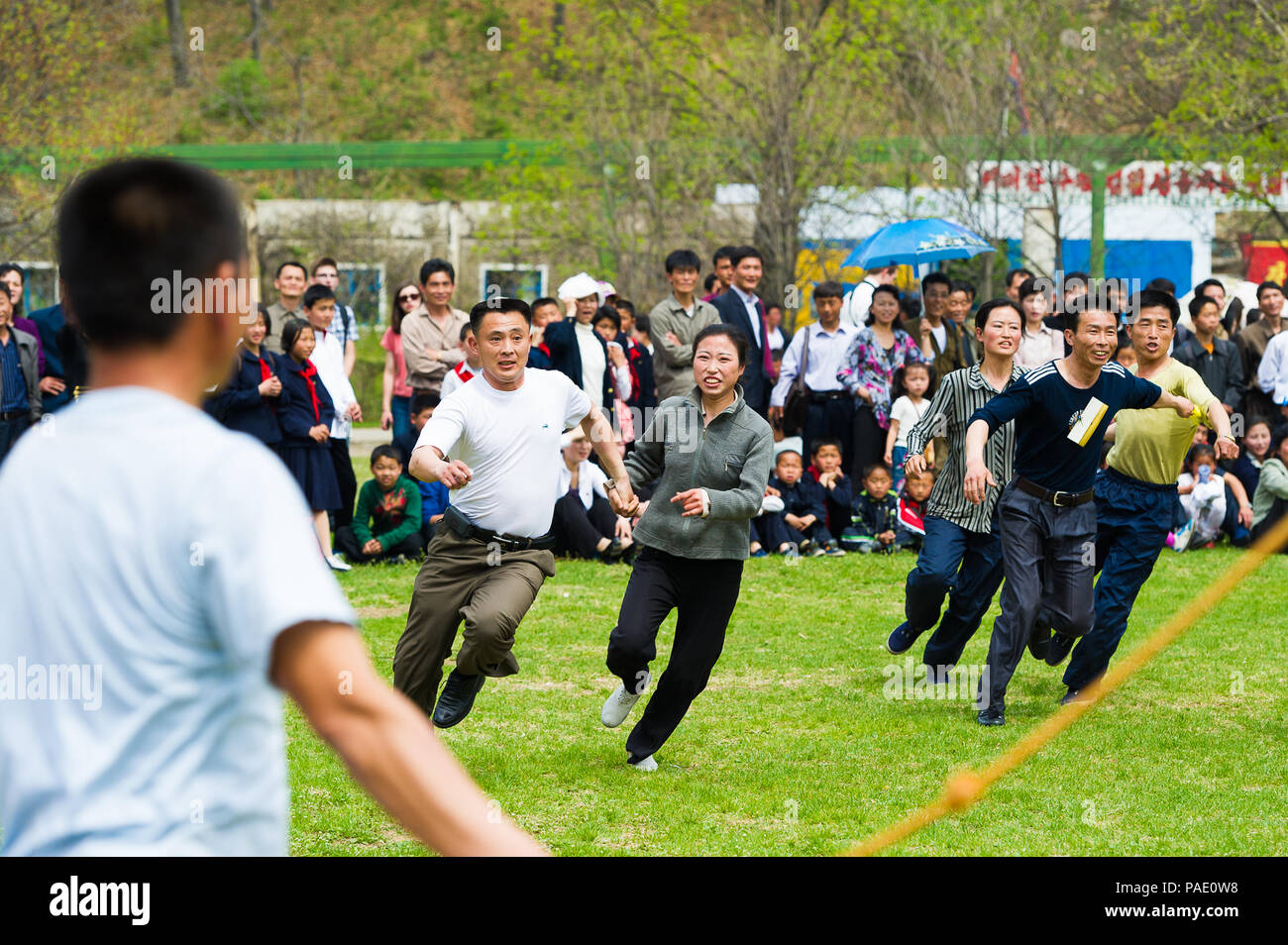 NORTH KOREA - MAY 1, 2012: Korean people jump over a skipping rope ...