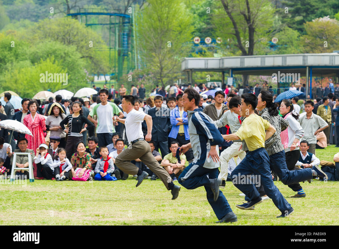 NORTH KOREA - MAY 1, 2012: Korean families jump over a skipping rope ...