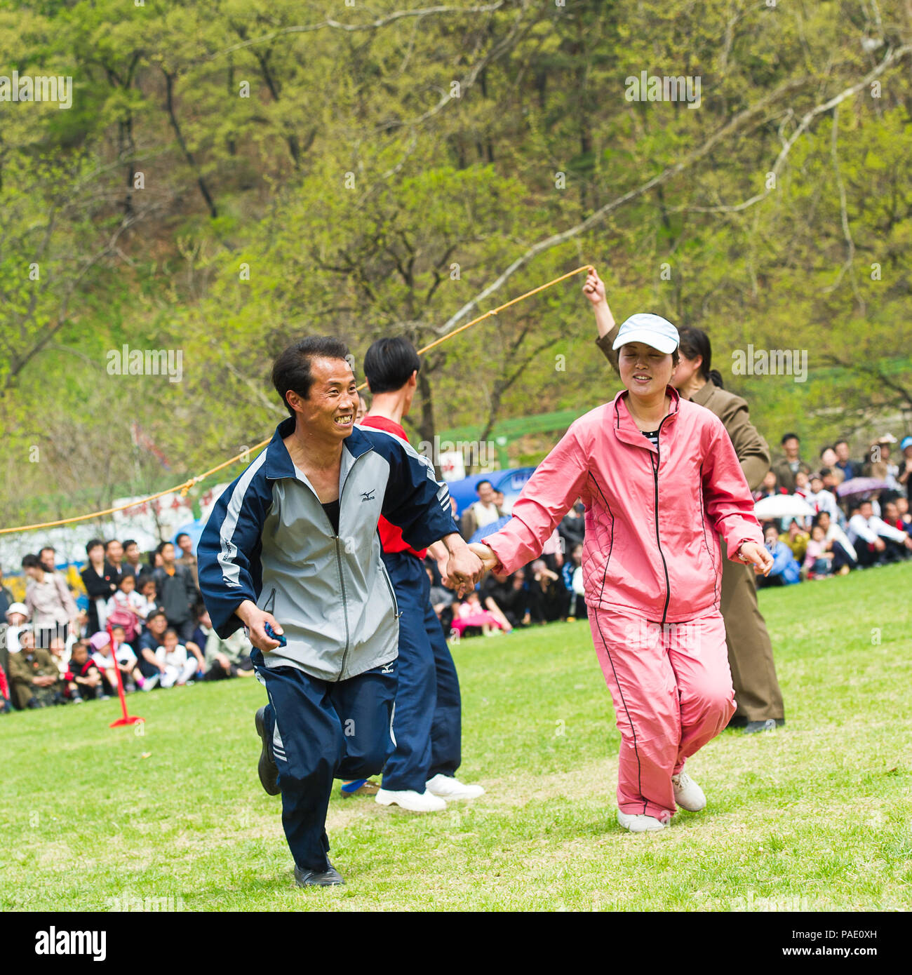 NORTH KOREA - MAY 1, 2012: Korean families jump over a skipping rope ...