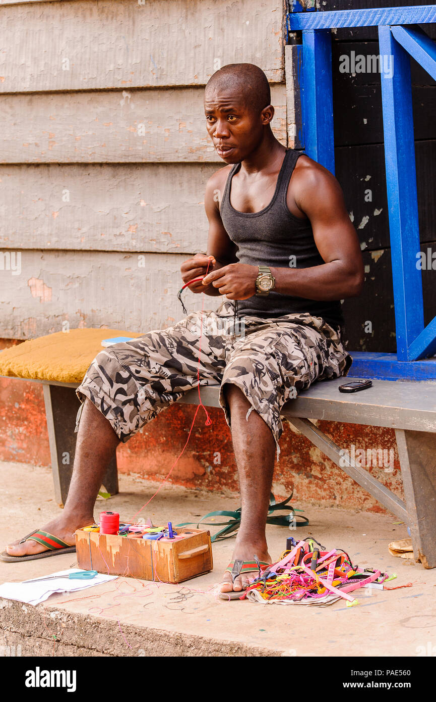 ACCRA, GHANA - MARCH 4, 2012: Unidentified Ghanaian man makes cables in ...