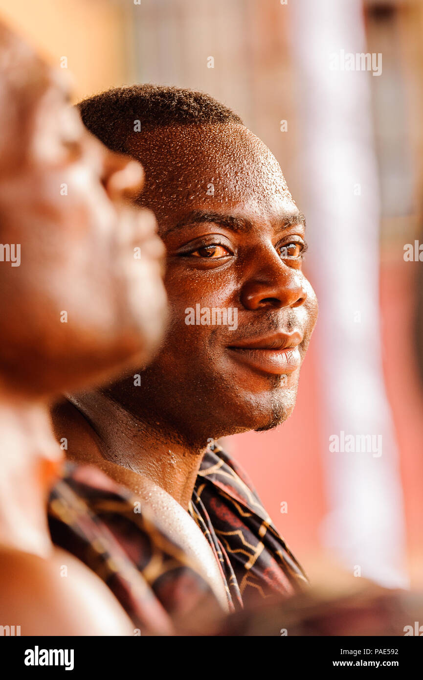 GHANA - MARCH 3, 2012: Unindentified Ghanaian man watches the girl ...