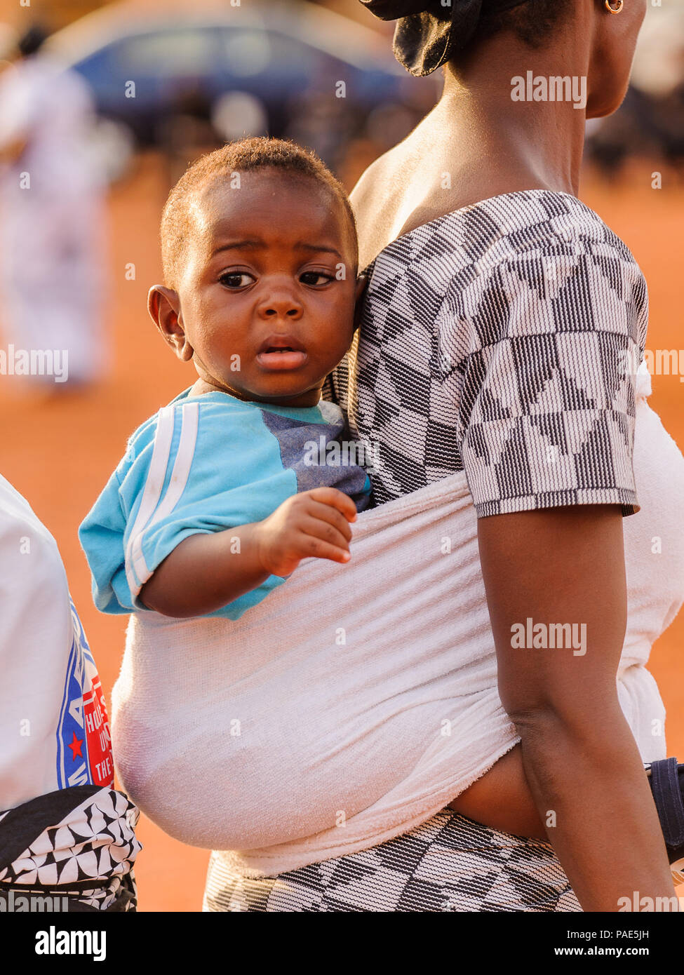 ACCRA, GHANA - MARCH 4, 2012: Unidentified Ghanaian baby on his mother ...