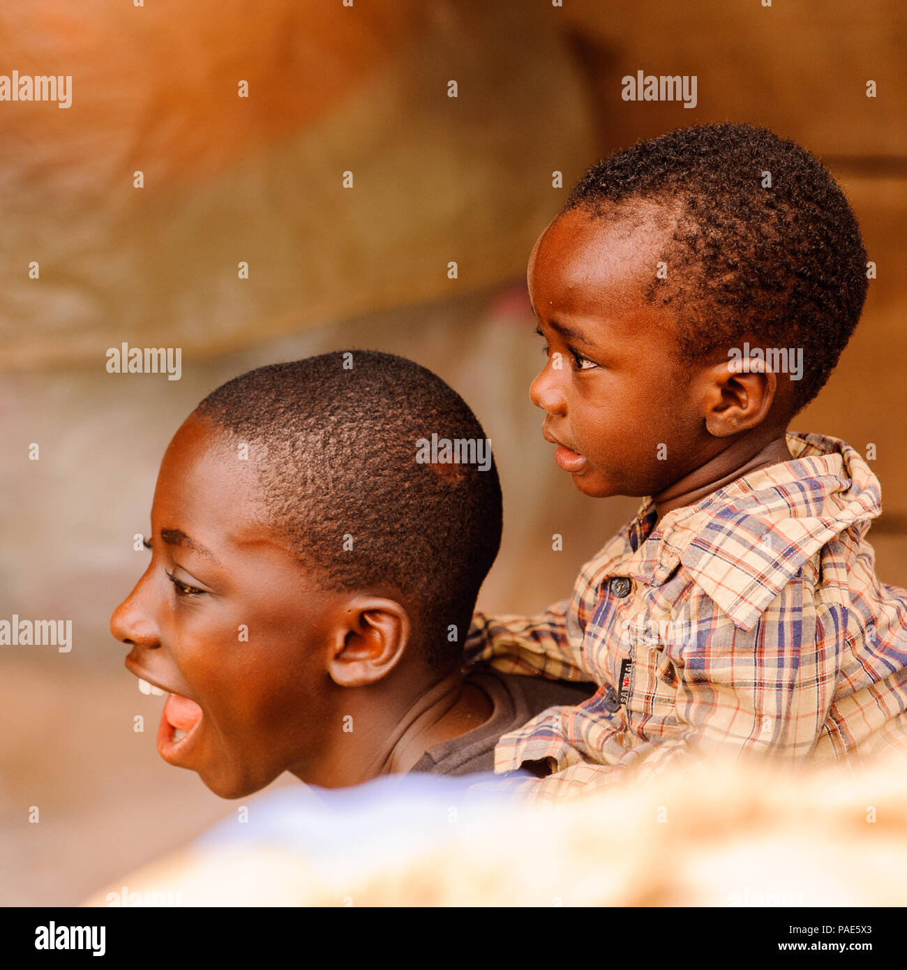 ACCRA, GHANA - MARCH 4, 2012: Unidentified Ghanaian boy carries his ...