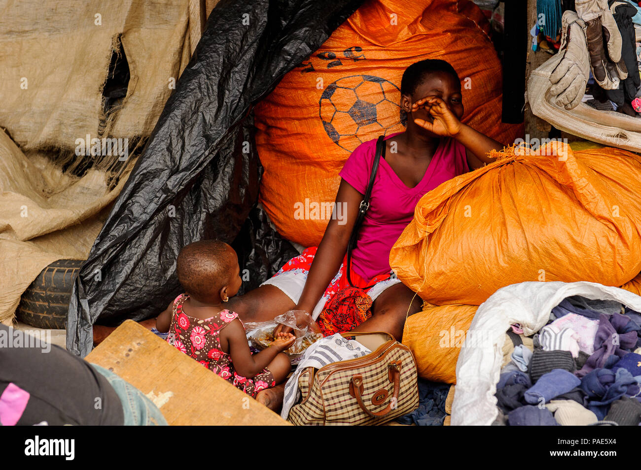 ACCRA, GHANA - MARCH 4, 2012: Unidentified Ghanaian woman and her child ...
