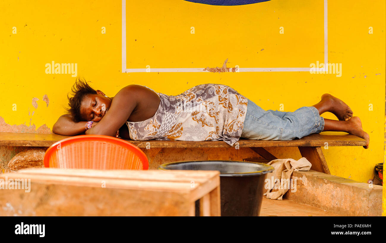 ACCRA, GHANA - MARCH 4, 2012: Unidentified Ghanaian woman sleeps on a ...