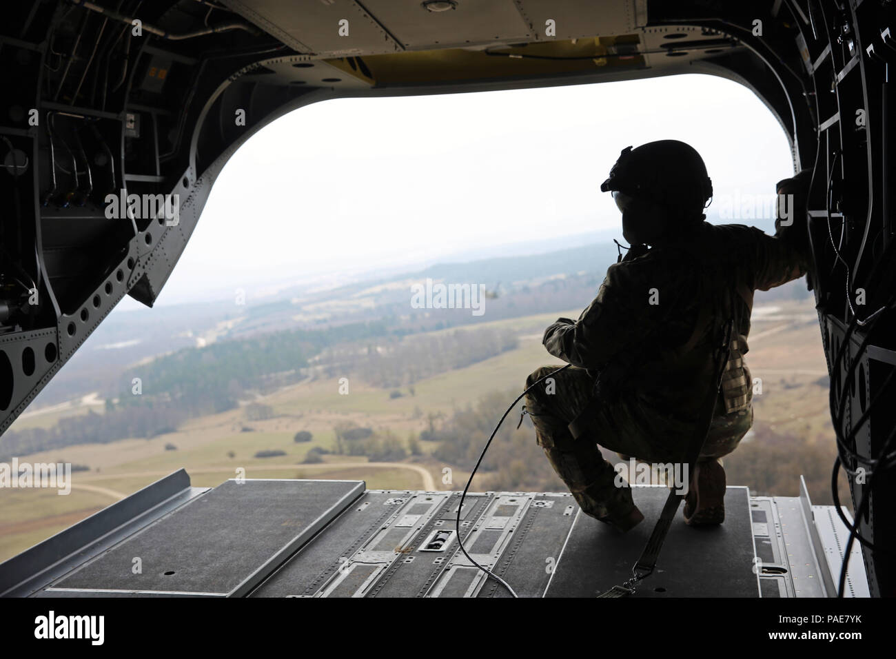 A crew chief assigned to 12th Combat Aviation Brigade looks out the ...