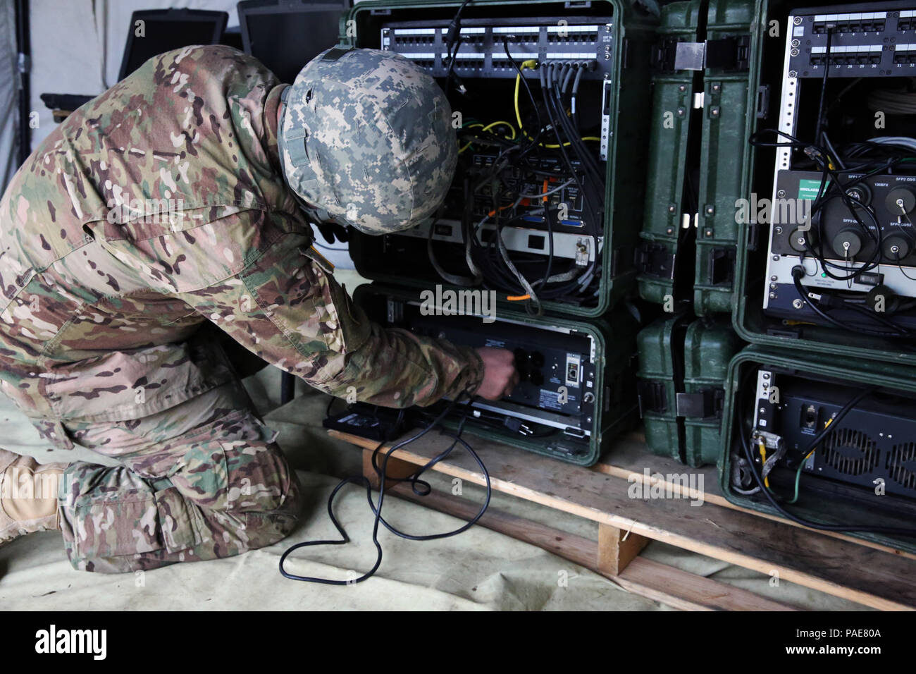A Soldier from the 44th Expeditionary Signal Battalion, 2nd Signal Brigade, works to establish a ...