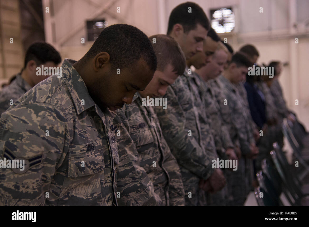 U.S. Air Force Airmen from the 820th Base Defense Group bow their heads ...