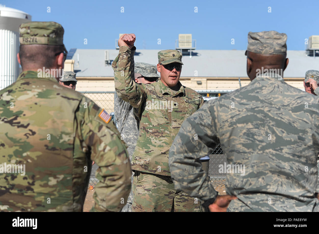 A training instructor demonstrates the pack strap carry to Operational ...