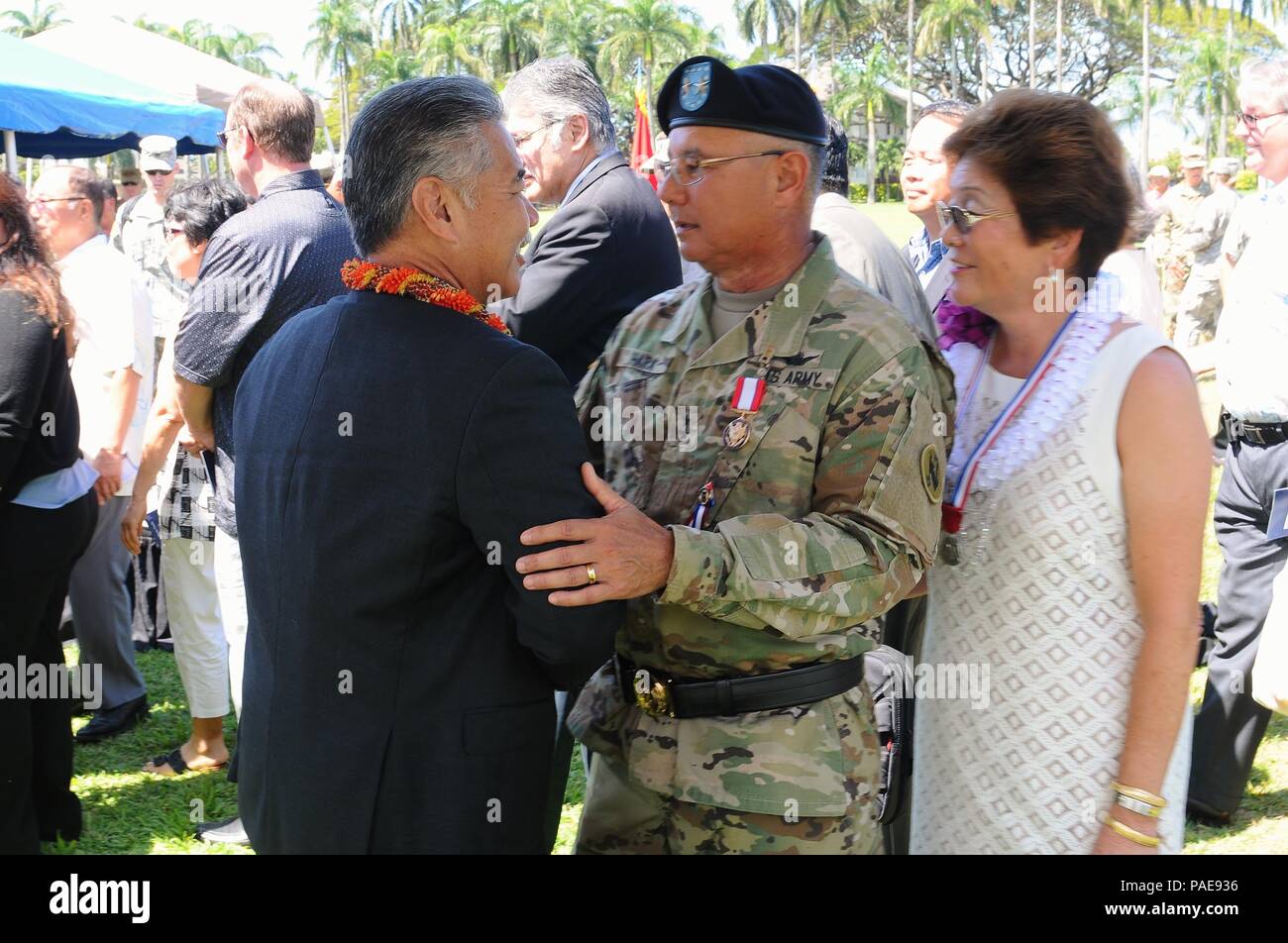 Governor of Hawaii, David Ige (left), congratulates Hawaii native, Maj ...
