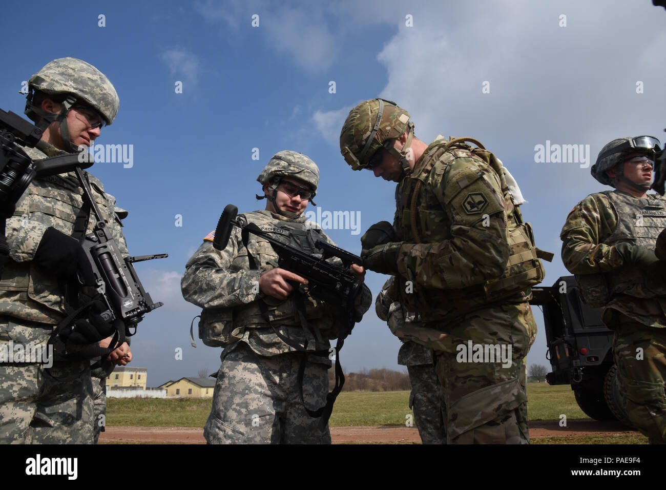 Sgt. Kyle Osborn, (center), checks Sgt. Joseph Pacheco’s M-203 grenade ...