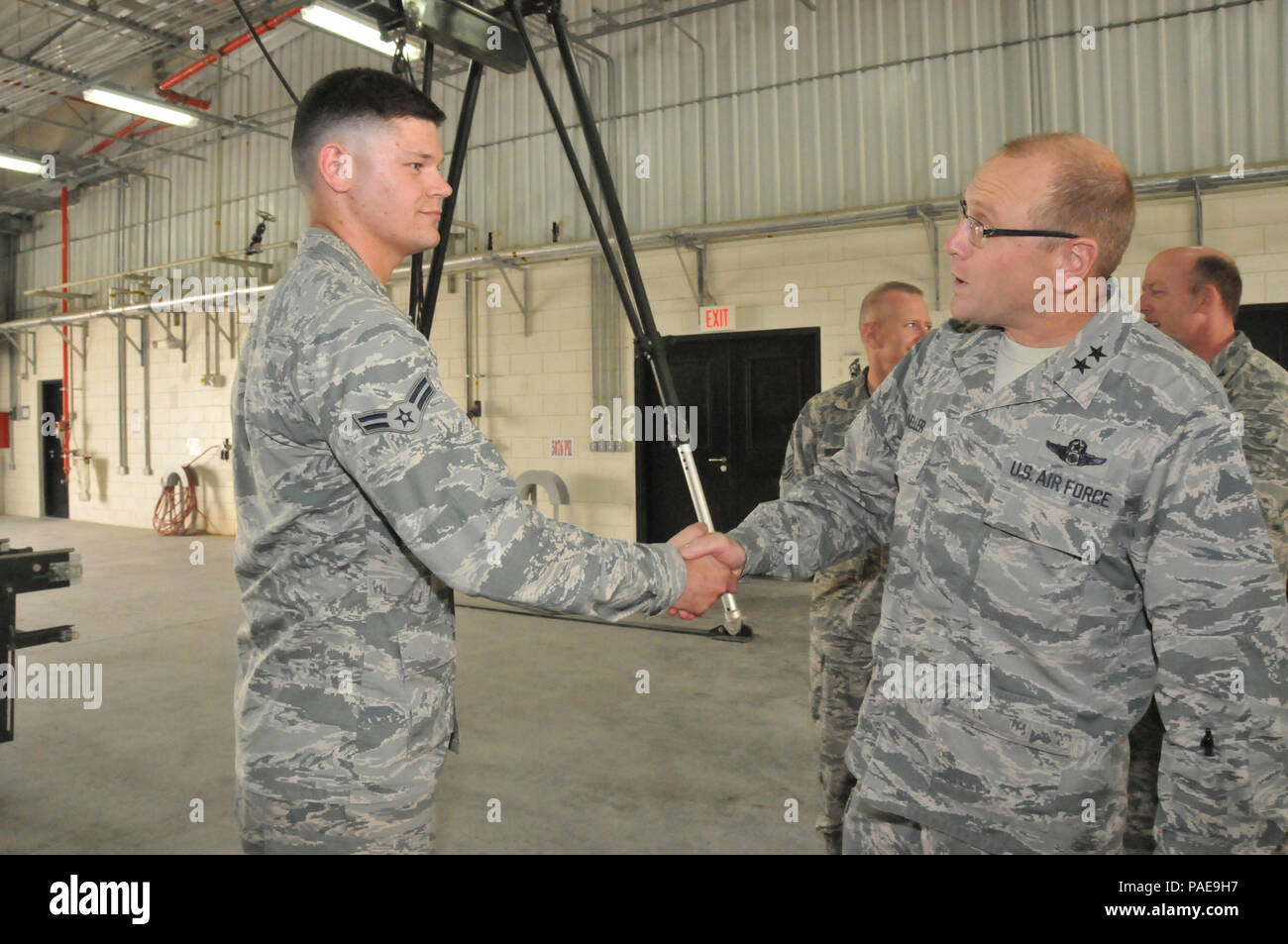 Maj. Gen. Andrew Mueller (right), Air Force Chief of Safety, coins ...