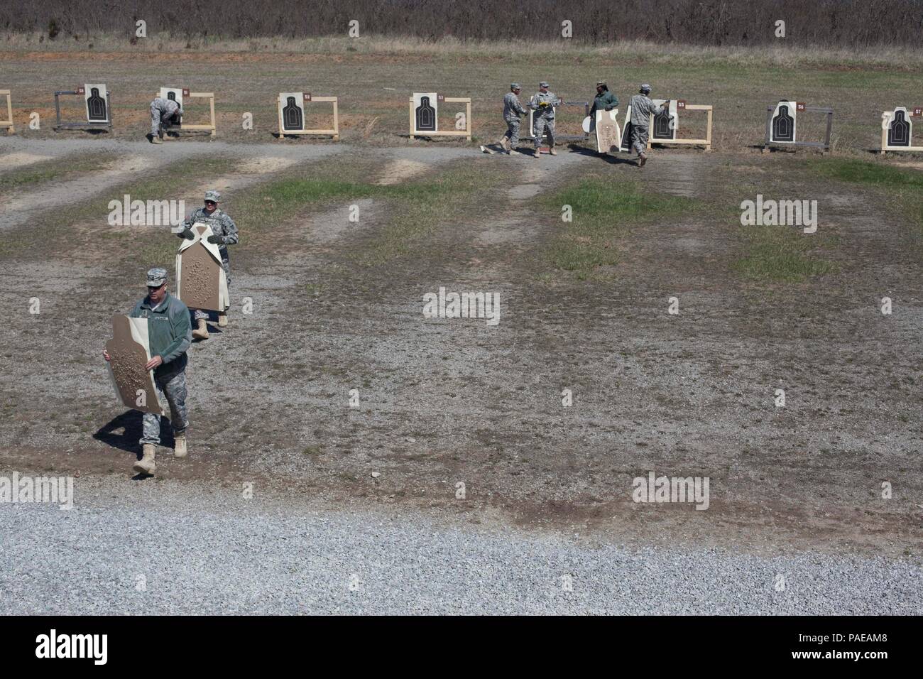 U.S. Army Soldiers exchange used targets for new at the m9 pistol range ...