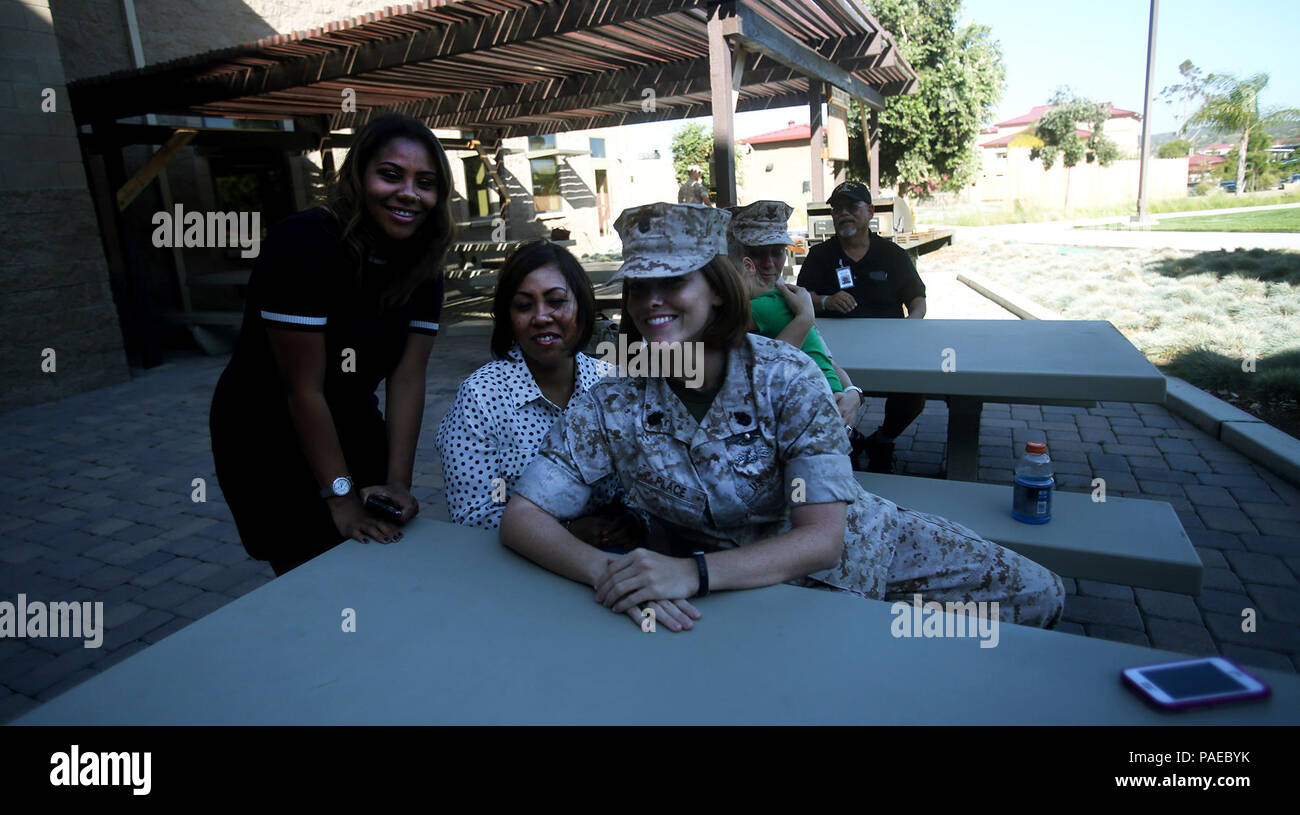 Chief Petty Officer Jaclyn Place poses for a photo with her neighbors ...