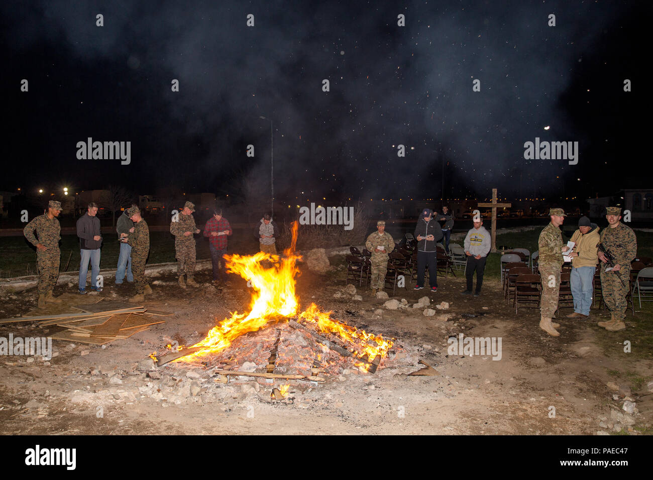 U.S. Service members gather around a bonfire before an Easter sunrise ...