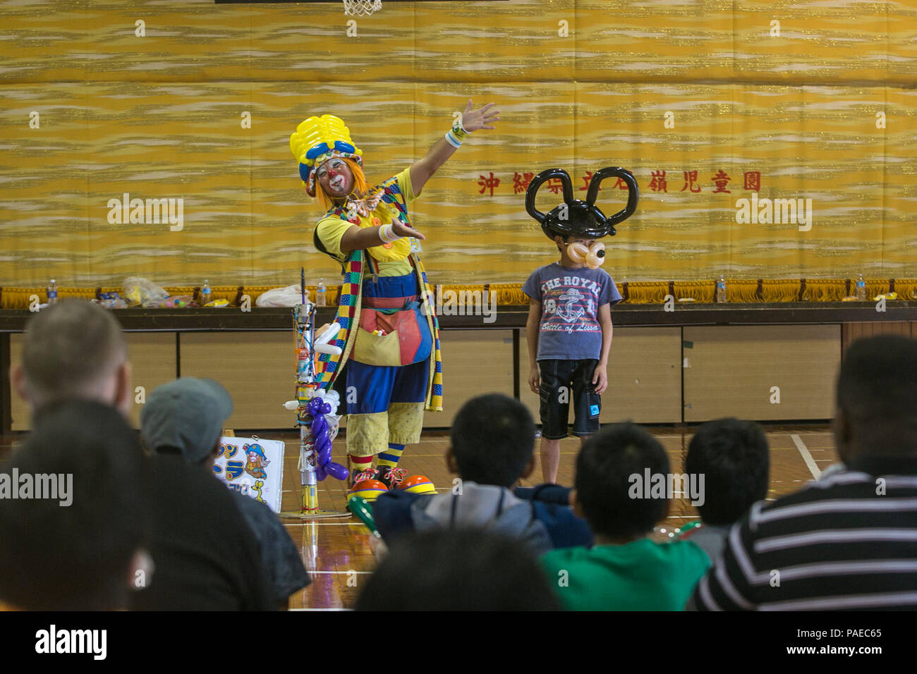 A clown poses with a child during the Ishimine Children’s Shelter ...
