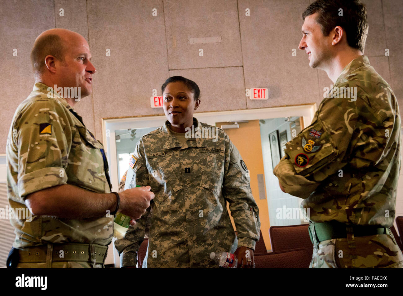 U.S. Army Capt. Lesa Sylve talks with Royal Navy Maj. Tony Philogene ...