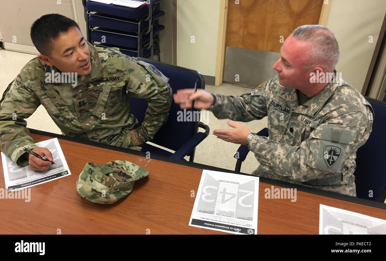 Capt. Li Xu (left), commander of HHC, U.S. Army Operational Test ...