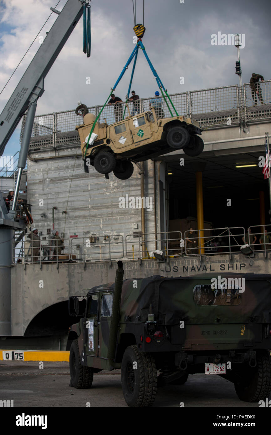 U.S. Marines and Sailors off-load an M998 High Mobility Multipurpose ...
