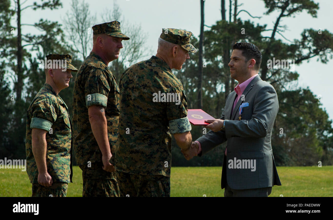 U.S. Marine Corps Sgt. Matthew S. Parker, right, retired, shakes hands ...