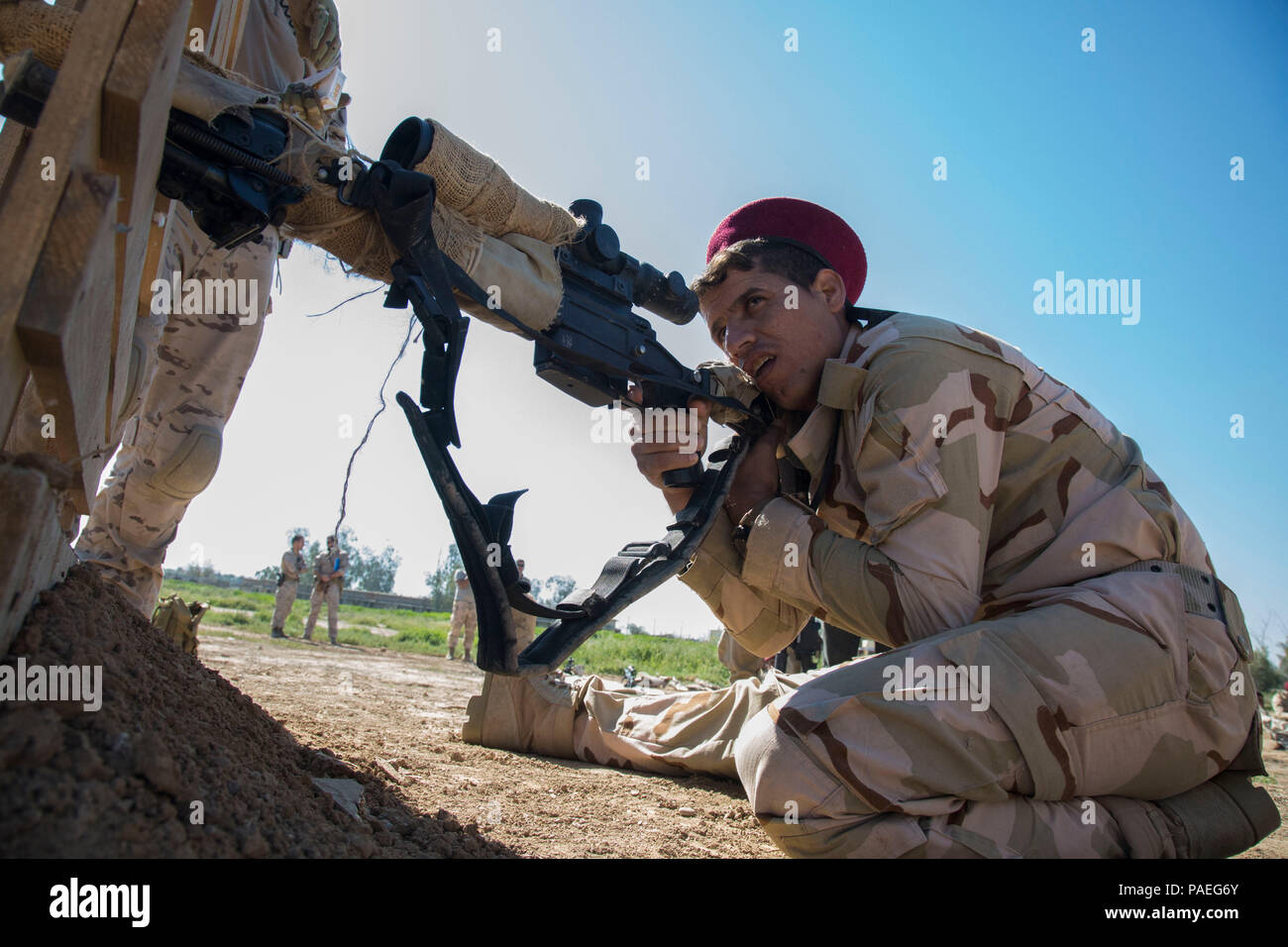 An Iraqi soldier enrolled in Iraqi sniper school takes up a sitting ...
