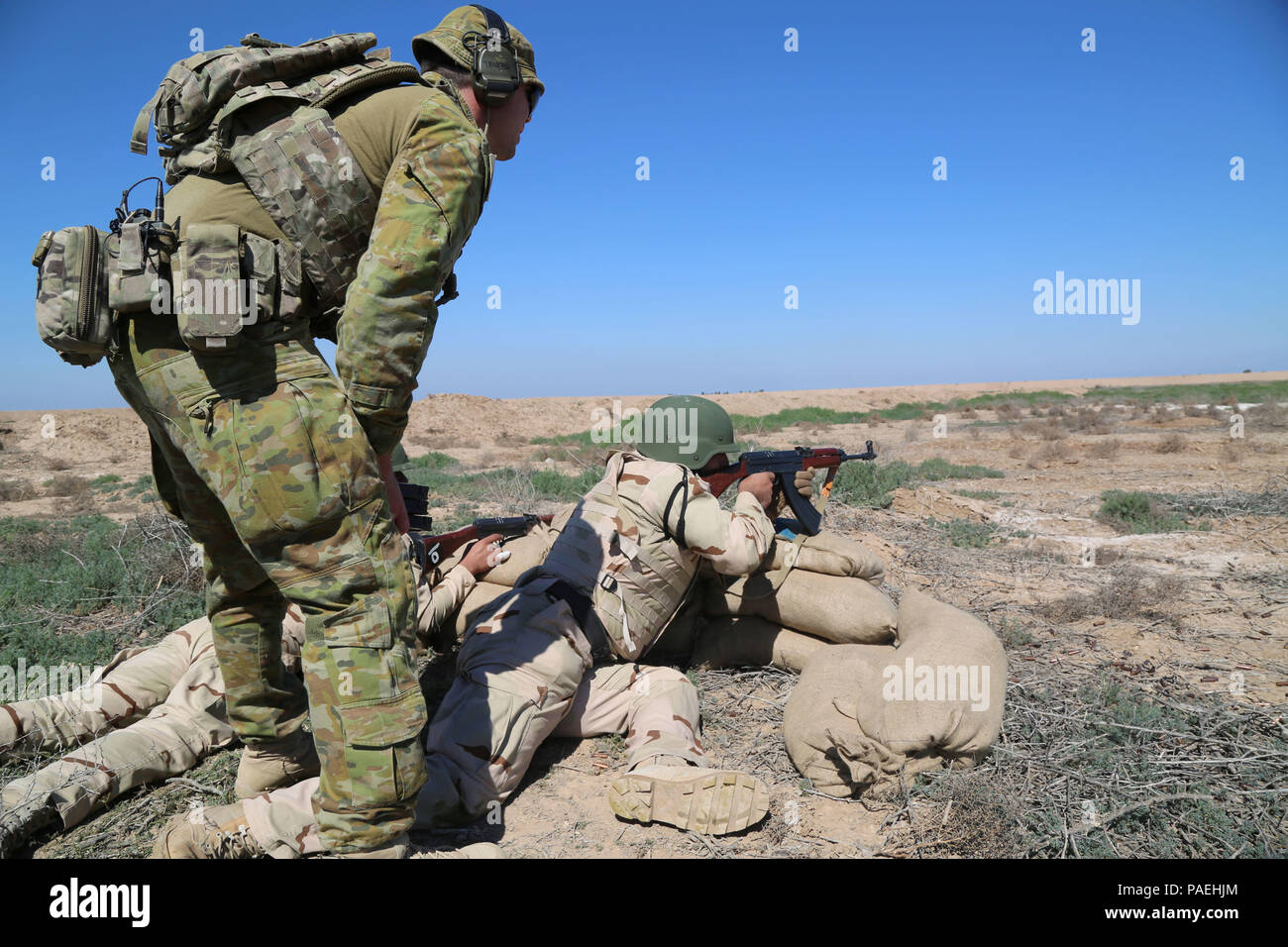 An Australian soldier, with Task Group Taji, observes an Iraqi soldier ...