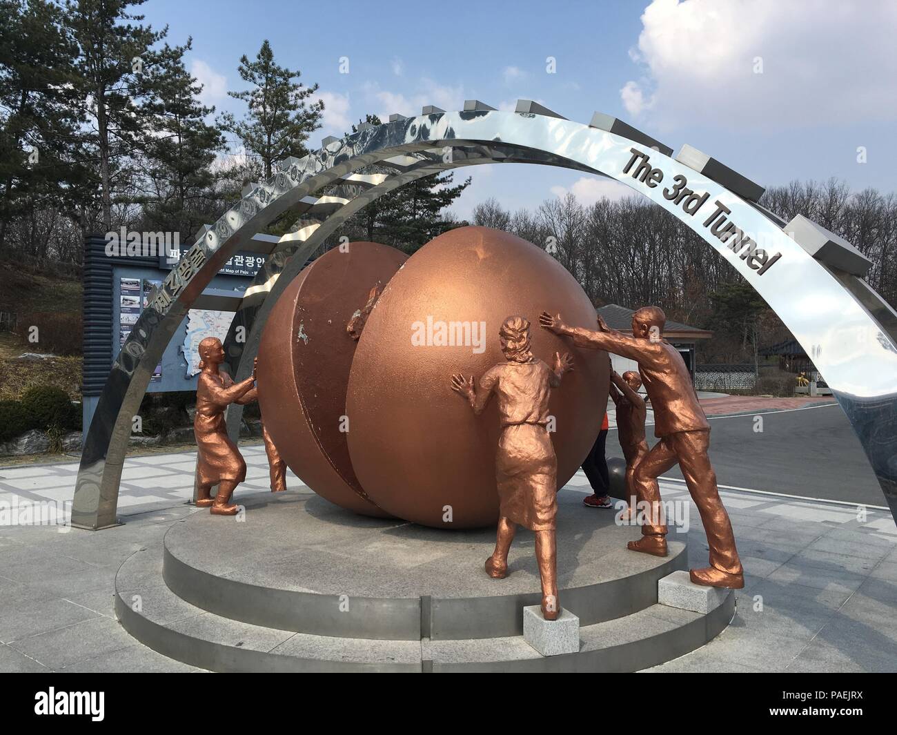Figures attempt to push the world together in a sculpture named “This ...