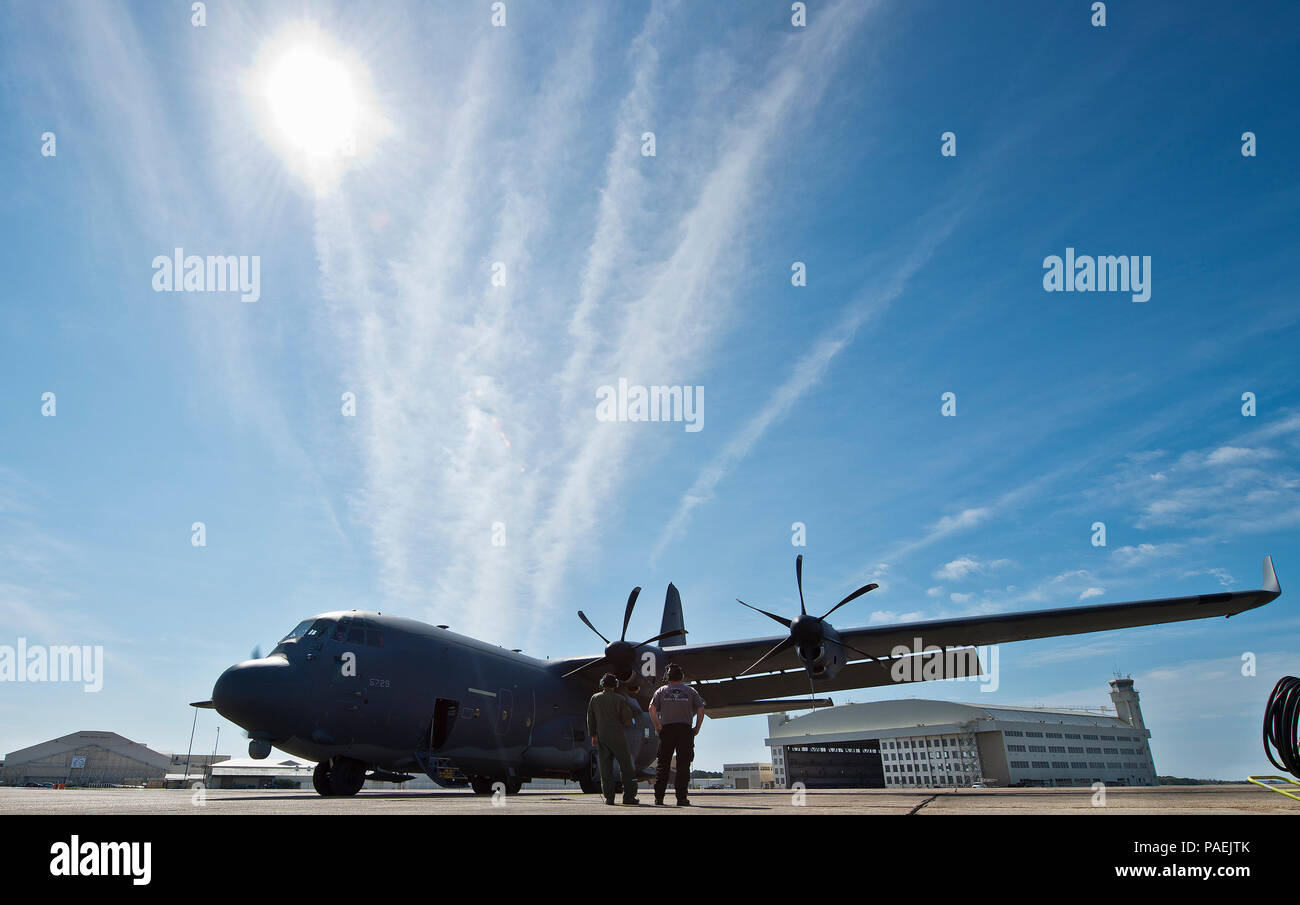 A maintainer and loadmaster watch as the MC-130J’s engine spins up ...