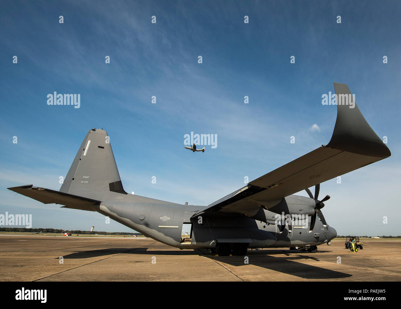 A modified MC-130J waits for its next mission as another C-130 lifts ...