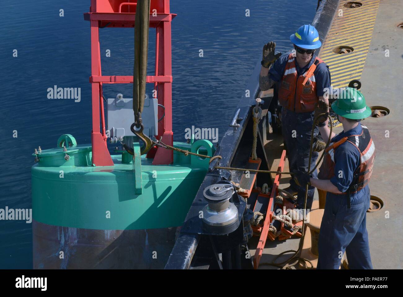 Coast Guard Cutter SPAR crew members conduct a buoy evolution aboard ...