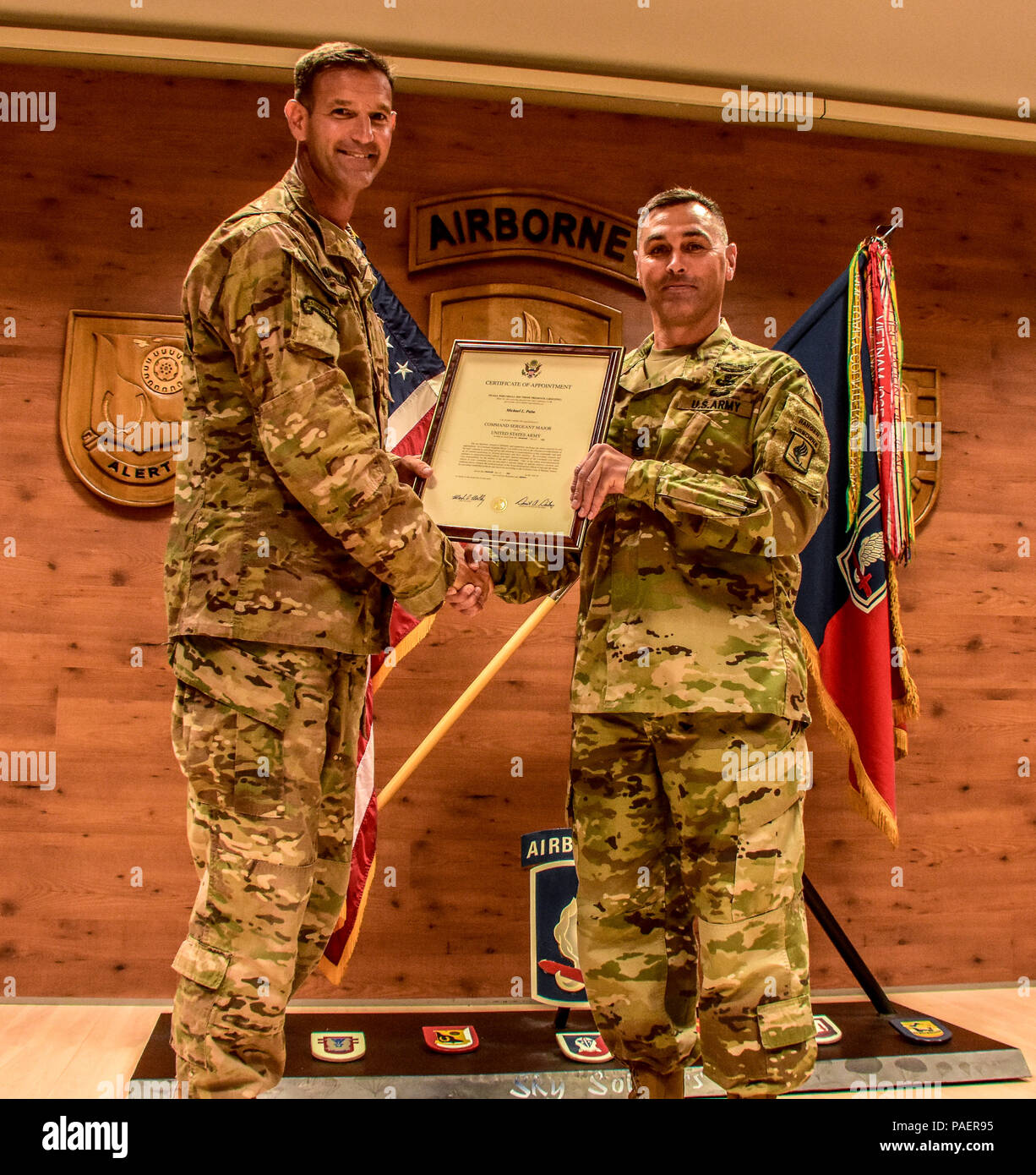 COL James Bartholomees, commander of the 173rd Airborne Brigade, presents CSM Michael Palm with ...