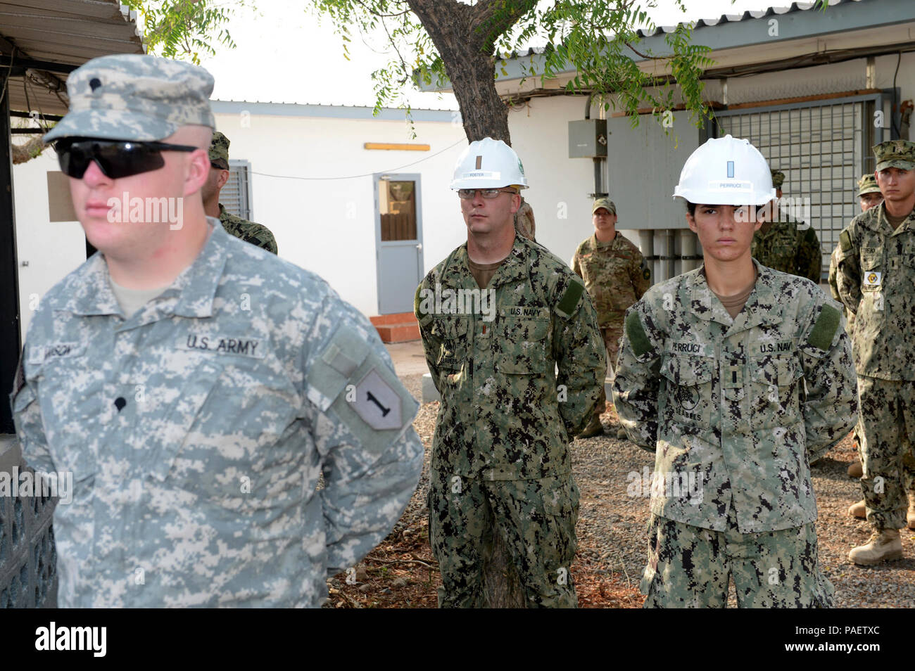 Sailors assigned to Naval Mobile Construction Battalion (NMCB) 11 stand ...