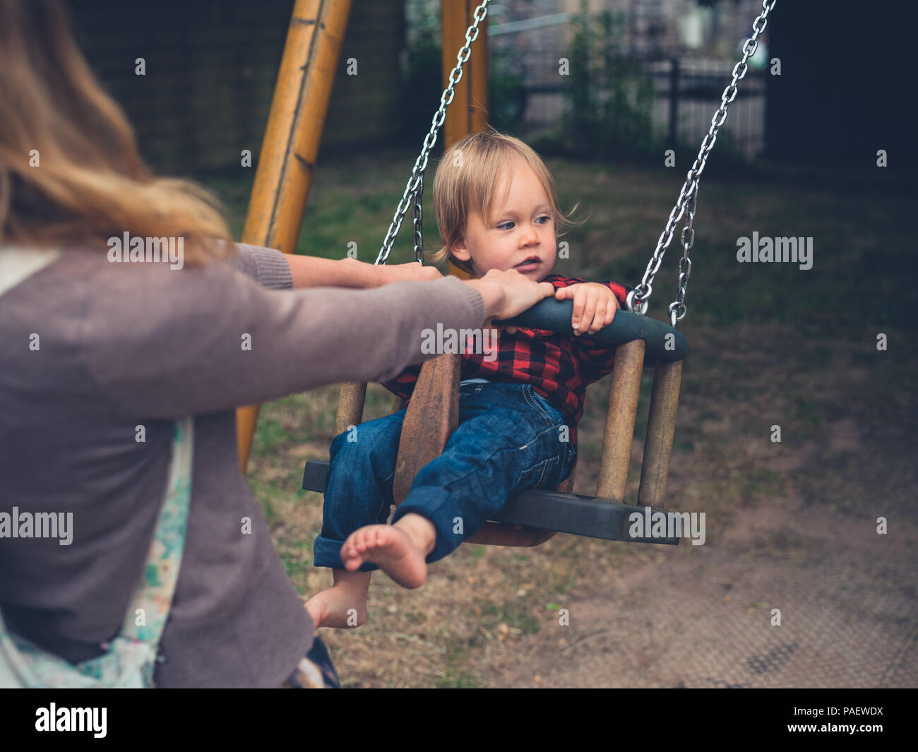 Parent pushing child swing hi-res stock photography and images - Alamy