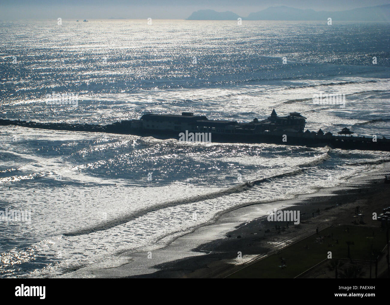 Background of a pier with gentle waves hitting the shore Stock Photo ...