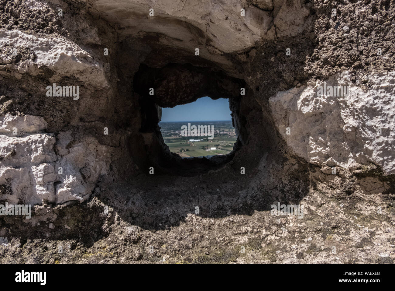 Landscape view from a tiny hole of a stone ancient wall Stock Photo - Alamy