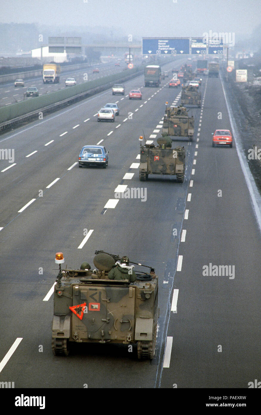 A convoy of M113 armored personnel carriers travel on a highway near ...