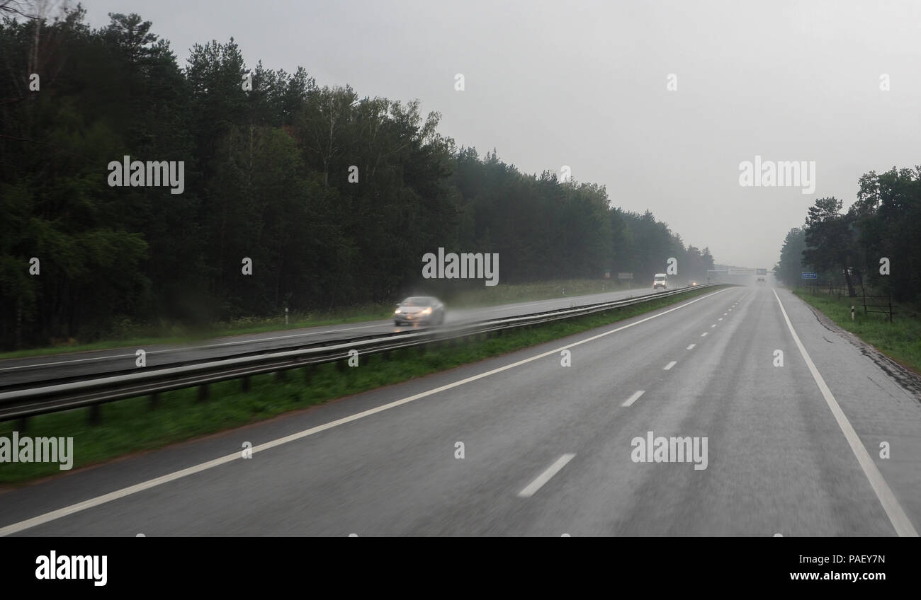 Countryside road and several cars in rainy overcast day Stock Photo - Alamy