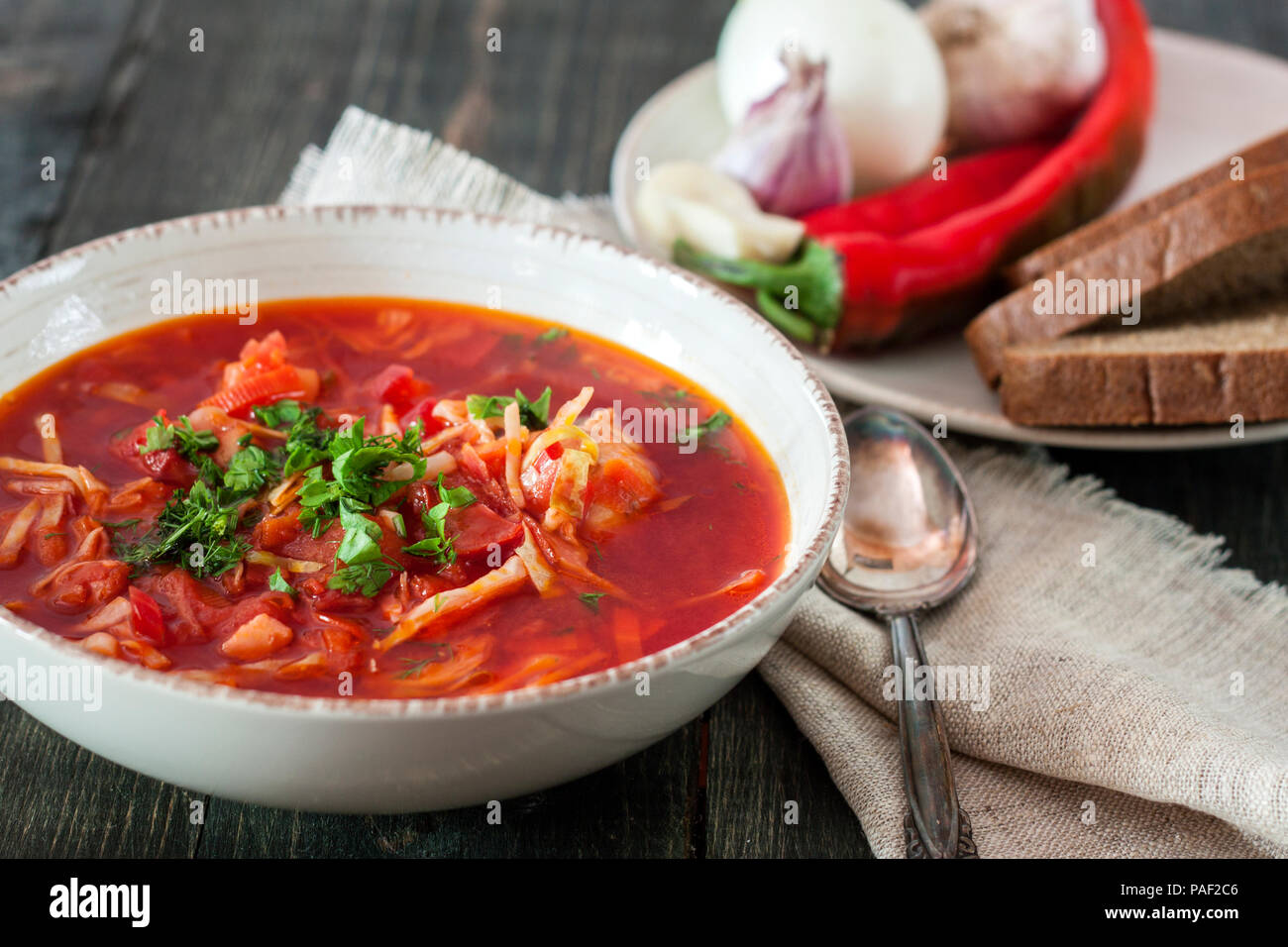 Traditional Ukrainian borscht in a plate. A plate on a black rustic ...